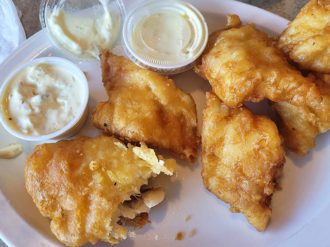 Golden-battered cod that shatters with each bite, revealing pearly white flesh within. This isn't just fried fish&mdash;it's the reason people drive across county lines.