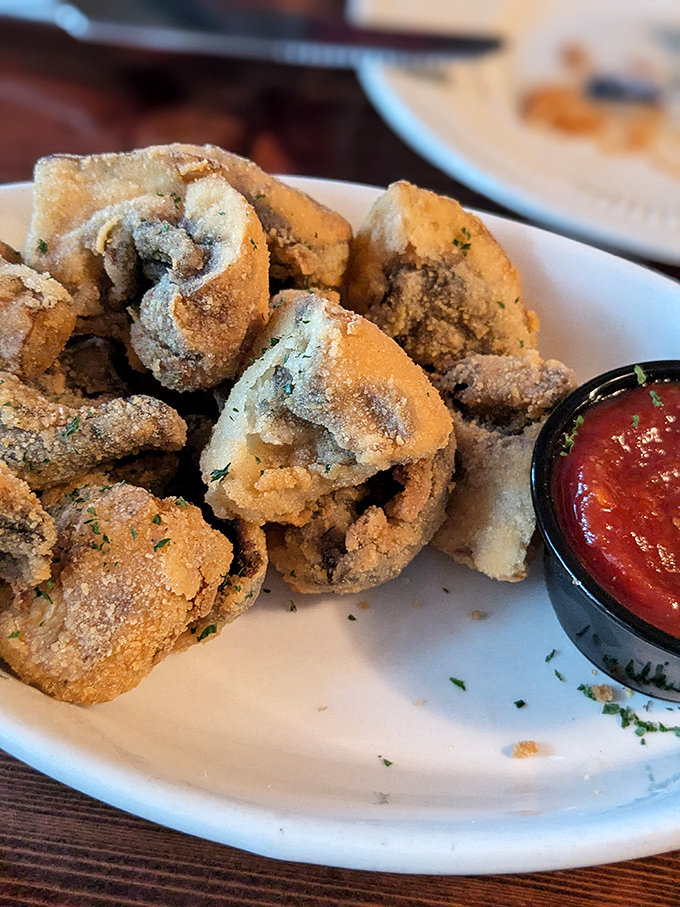 Golden-brown fried oysters that shatter with each bite, revealing briny treasures within. The cocktail sauce stands ready for its supporting role.