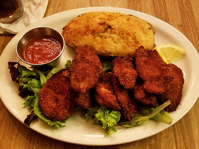 These golden-fried oysters aren't just appetizers&mdash;they're little crispy jewels of the sea, served with a cornbread sidekick that deserves its own fan club.