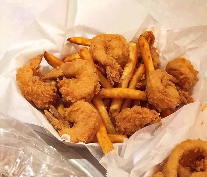 Golden-fried shrimp nestled among crispy fries &ndash; proof that sometimes the simplest preparations deliver the most satisfying bites.