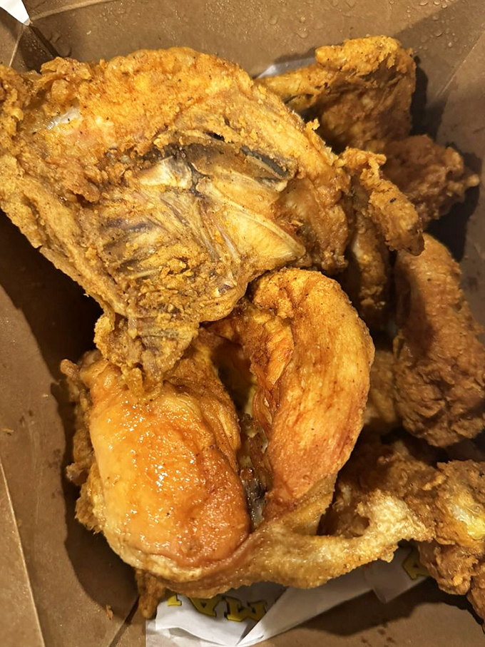 Golden-brown perfection in a box. This fried chicken's crackling exterior promises that first satisfying crunch before revealing juicy meat that's worth every napkin.