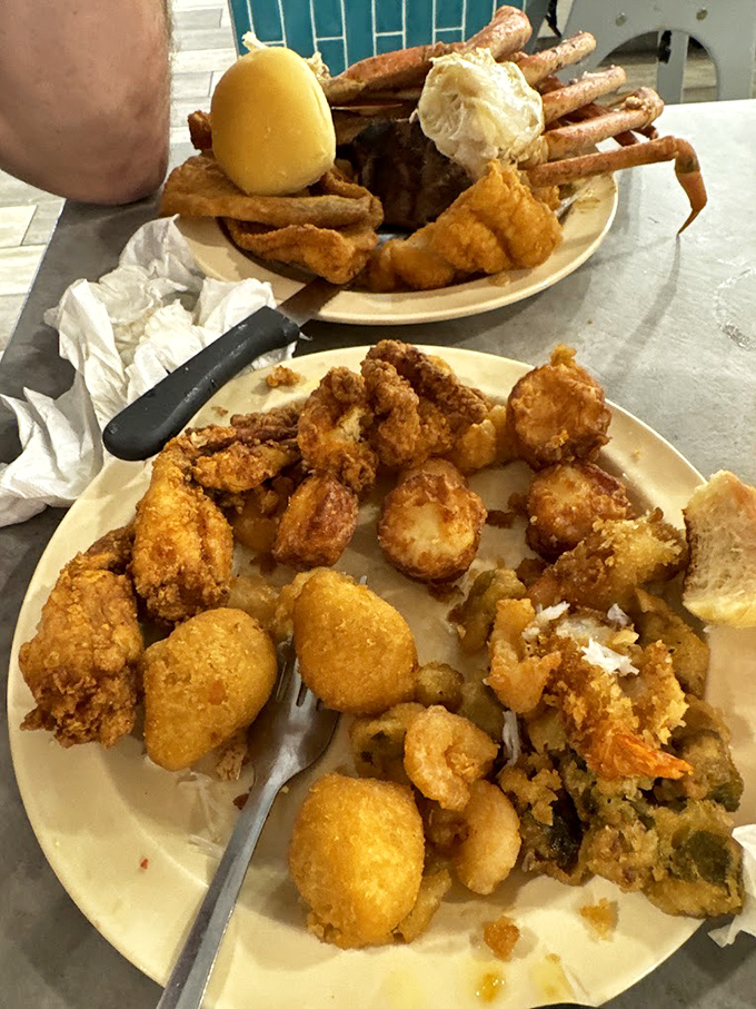 A seafood lover's dream plate: golden-fried delights alongside those magnificent crab legs. This isn't just dinner&mdash;it's an expedition requiring proper tools and strategy.