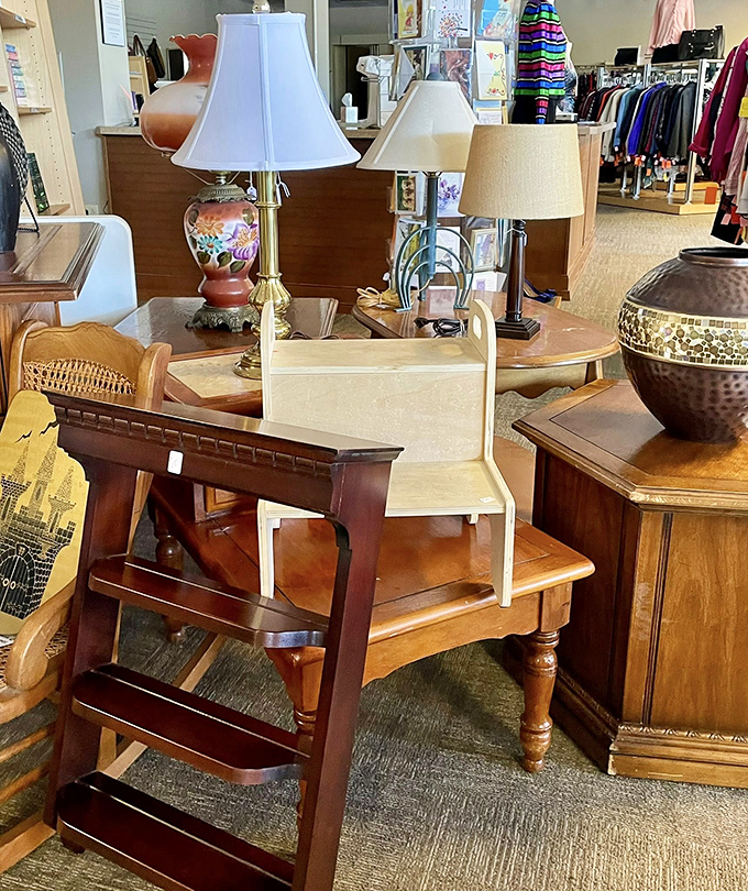 Furniture that tells stories sits patiently waiting for its second act. That wooden step stool has probably witnessed more family dinners than most restaurants. 