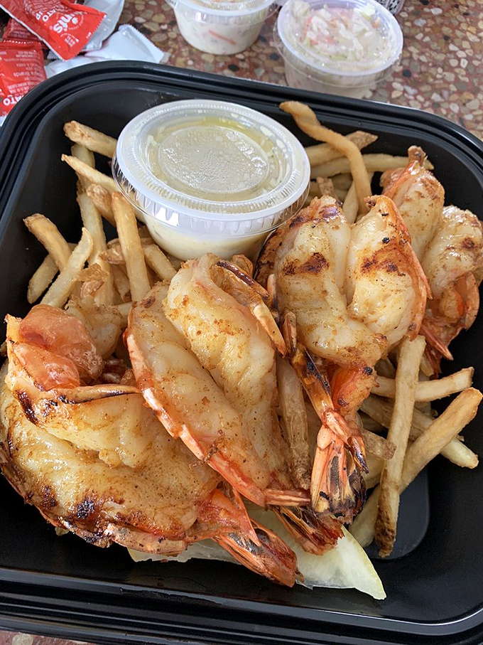 These aren't shrimp, they're practically lobster's first cousins, grilled to golden perfection with fries for backup.