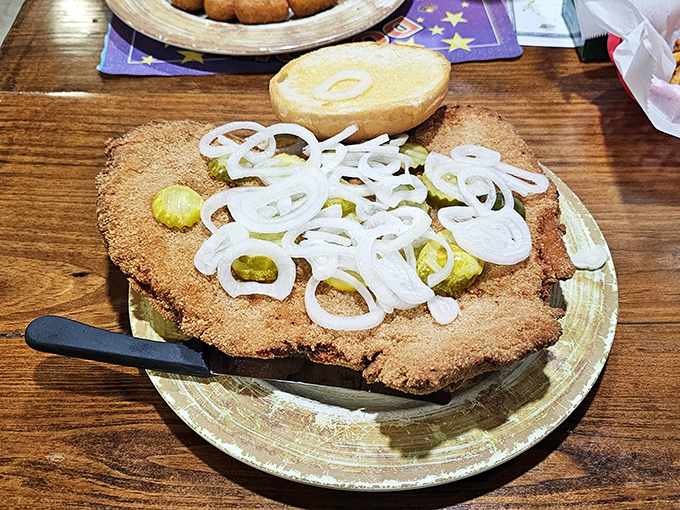 Behold the tenderloin that ate Indianapolis – it's less sandwich, more edible geography lesson with pickles for scale.