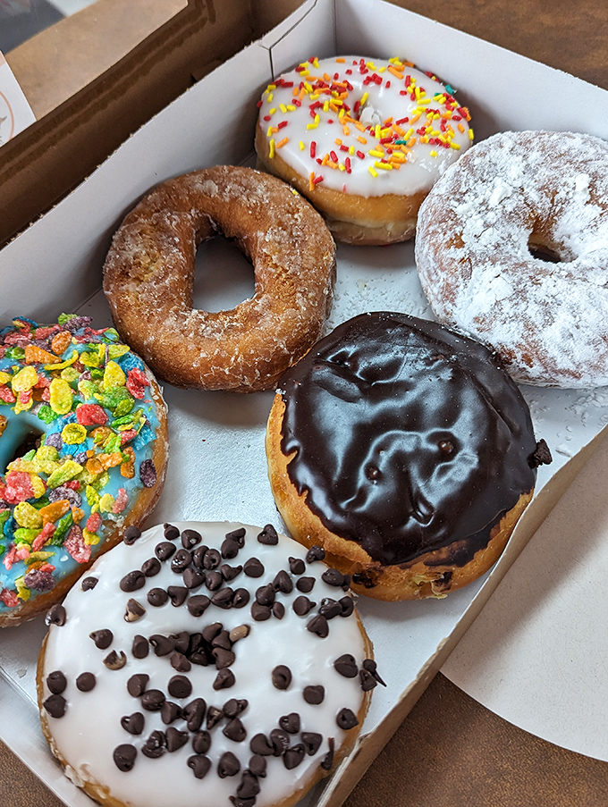 The box of possibilities! From fruity pebble-topped creations to classic chocolate glazed, this half-dozen represents serious life decisions.