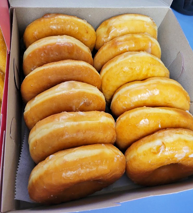 Golden pillows of perfection lined up like soldiers ready for delicious duty. These glazed beauties glisten with a promise they absolutely keep.