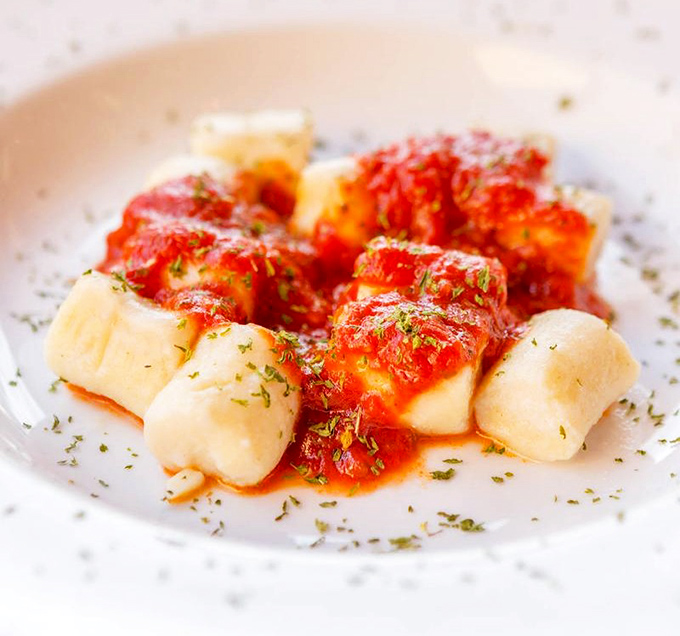 Pillowy potato perfection! These gnocchi surrender to your fork with just the right resistance before melting into a pool of bright, herb-flecked marinara.
