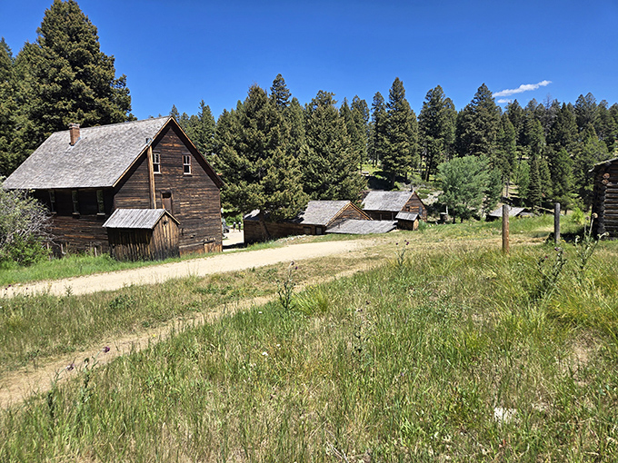 Weathered wooden structures stand as silent storytellers at nearby Granite Ghost Town, where dreams of silver once brought thousands to this now-peaceful mountainside.