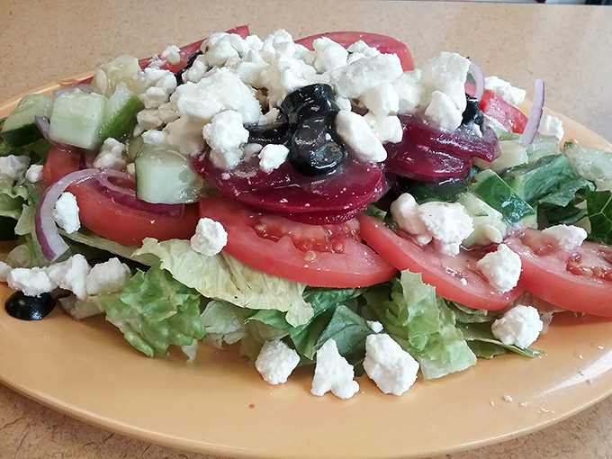 The Greek salad that launched a thousand return visits. Crisp vegetables, briny olives, and feta cheese crumbles unite in a Mediterranean masterpiece that Michigan has rightfully embraced.