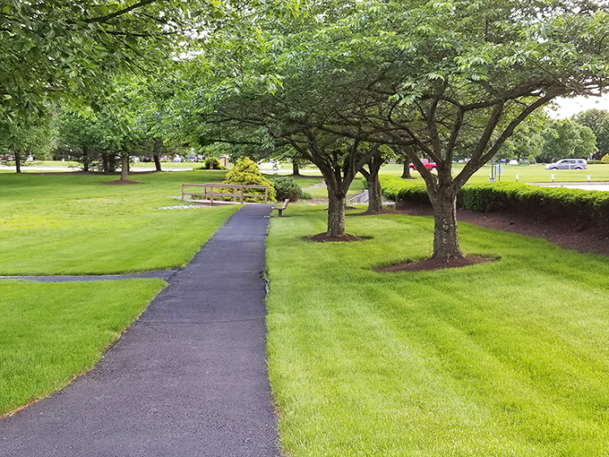 Winding paths through manicured grounds invite daily strolls where the biggest decision is which bench to rest on when admiring the view.
