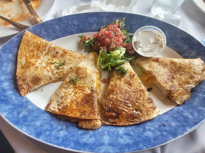 Golden-brown quesadilla triangles arranged like a delicious compass, pointing the way to flavor town with every crispy, cheesy bite.