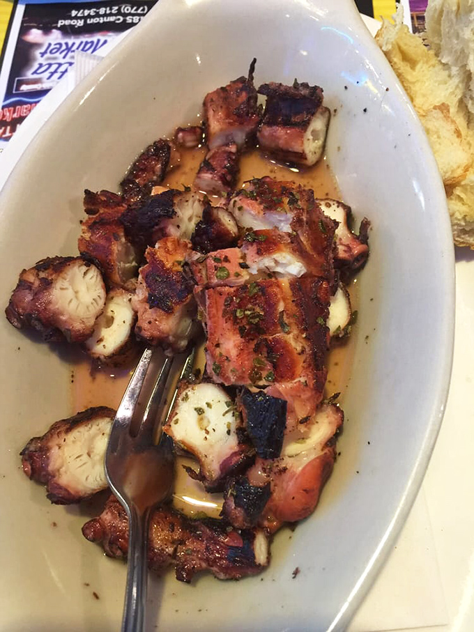 Grilled octopus that's charred to perfection—tender enough to make you forget you're eating something that once had more arms than your entire family.