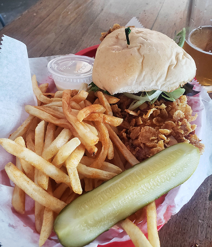The star of the show in all its golden-fried glory. That pickle isn't just garnish&mdash;it's the exclamation point at the end of a perfect culinary sentence.