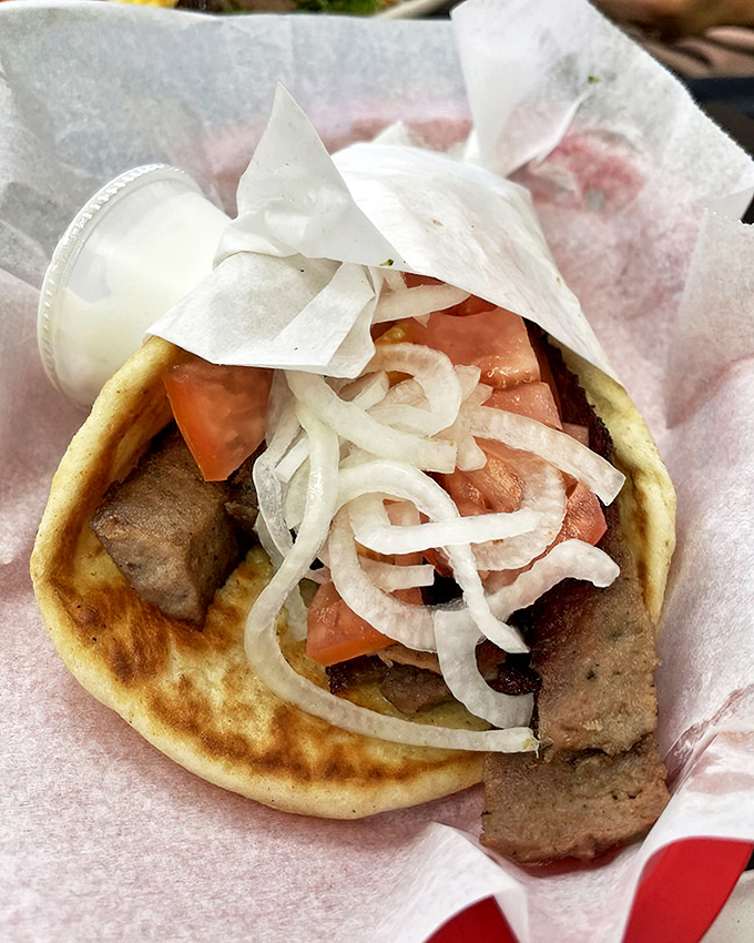 This gyro isn't just a sandwich&mdash;it's an architectural marvel of meat, veggies, and tzatziki. The kind of handheld masterpiece that demands both napkins and respect.