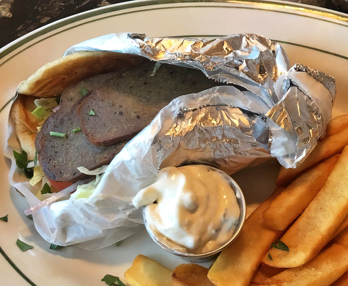 Behold the star attraction: a perfectly wrapped gyro with tzatziki that would make Zeus himself weep with joy.
