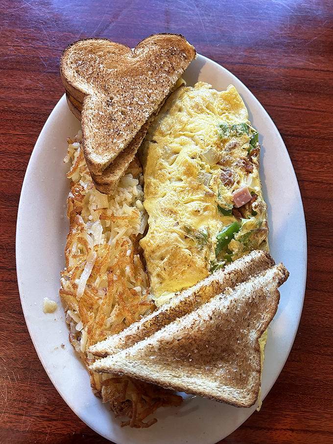 The Western omelet arrives like a sunrise on a plate &ndash; fluffy eggs embracing ham and vegetables with the kind of harmony world leaders should study.