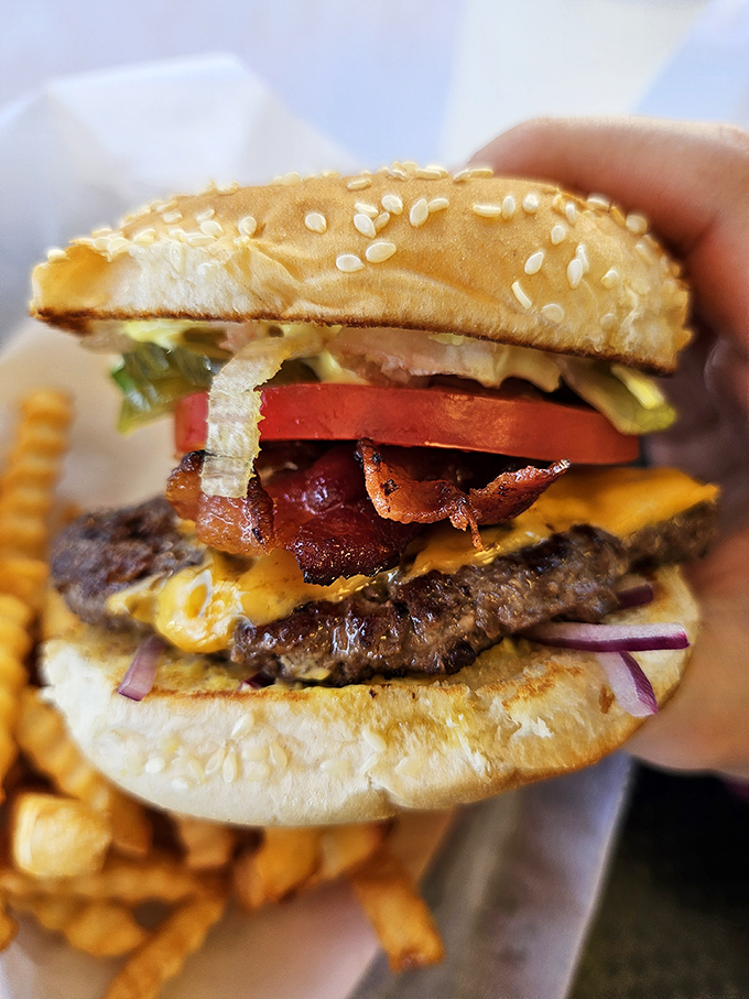 Behold the Lot-O-Burger in all its glory—where melted cheese, crisp bacon, and fresh veggies meet a patty that means serious business.