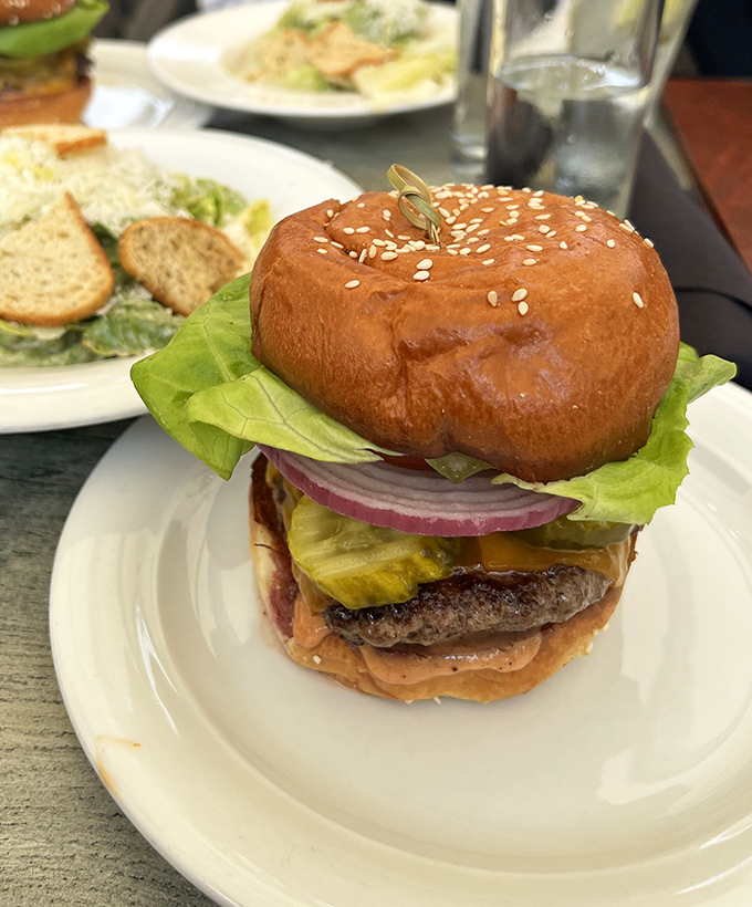 This isn't just a burger; it's a masterclass in beef architecture with a golden-brown bun that deserves its own California real estate listing.