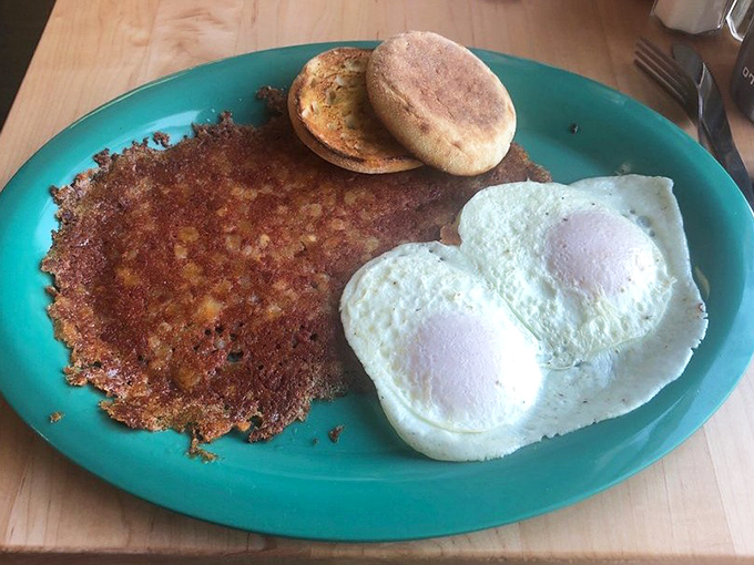 Two perfectly cooked sunny-side-up eggs alongside a crispy hash brown patty&mdash;proof that simplicity, when executed flawlessly, creates the most satisfying breakfast symphony. 