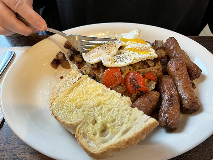 Breakfast nirvana: perfectly peppered eggs, golden hash browns, sausage links with that ideal snap, and toast that somehow makes all your life decisions seem correct.