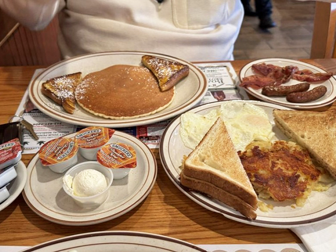 Breakfast perfection on display: golden pancakes, perfectly cooked eggs, crispy hash browns, and toast&mdash;the four food groups of diner happiness.
