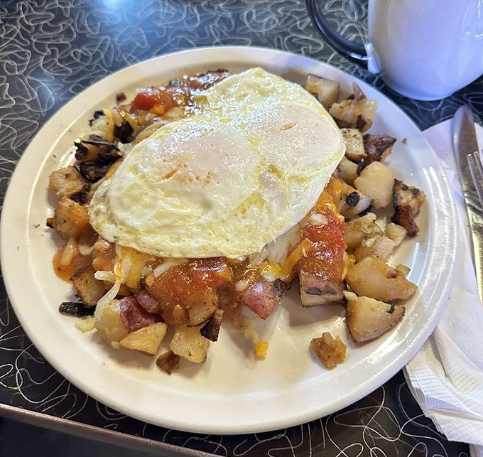 Sunny-side perfection crowns a mountain of seasoned potatoes&mdash;proof that sometimes the simplest breakfasts create the most profound happiness.