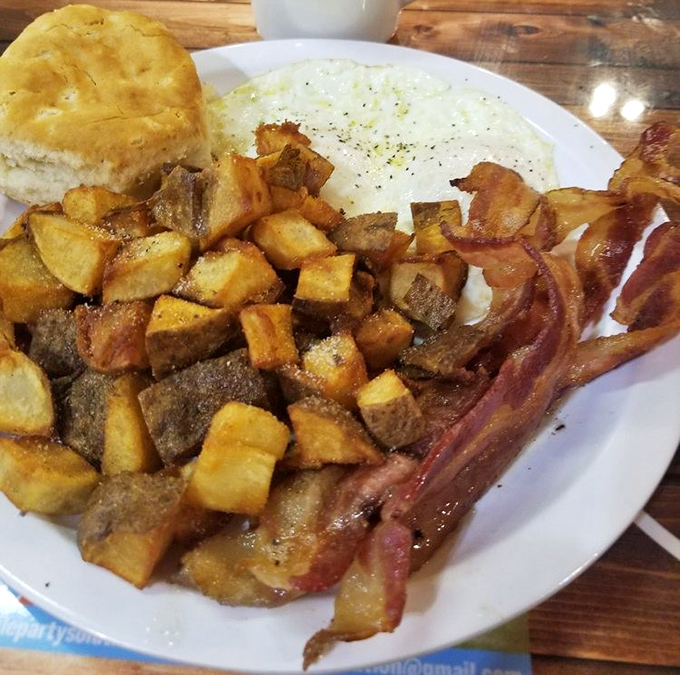 Breakfast perfection doesn't need filters. Golden home fries, crispy bacon, eggs cooked just right, and a biscuit that would make your grandmother jealous.