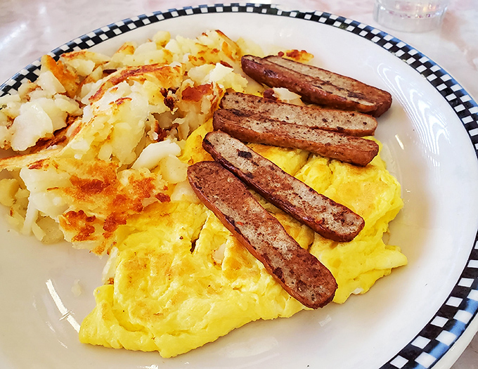 Sunshine on a plate: perfectly scrambled eggs, crispy home fries, and sausage links that snap with each bite&mdash;the breakfast trifecta.