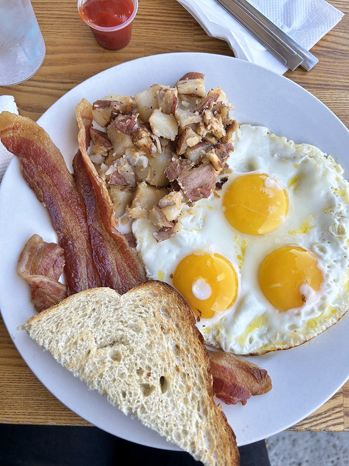 Breakfast perfection doesn't need filters&mdash;three sunny-side-up eggs, crispy bacon, and home fries that could make a potato proud.