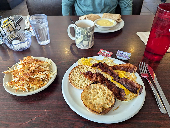 Breakfast perfection on a plate: golden hash browns, crispy bacon, and eggs that would make any chicken proud. This is why alarm clocks were invented.