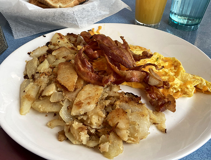 Home fries that actually taste like home, bacon crisped to perfection, and eggs that remind you why breakfast deserves its legendary status.