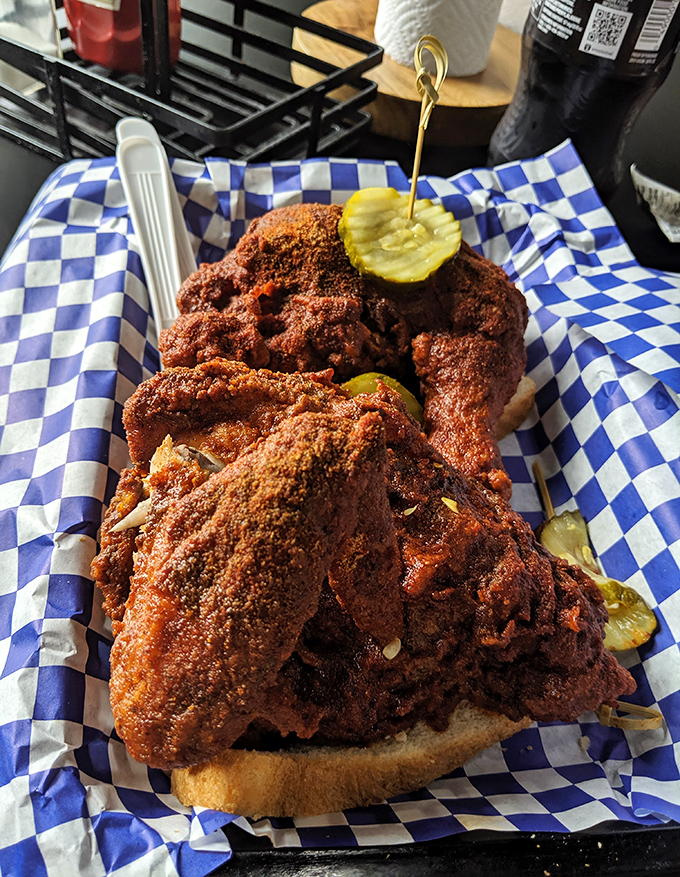 This isn't just chicken; it's a Nashville masterpiece. That deep russet coating hides a symphony of spices, with pickle chips offering the perfect cool counterpoint.