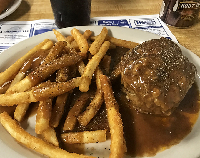 Behold the legendary hot hamburger steak in all its gravy-soaked glory. That golden-brown gravy cascading over crispy fries should be Pennsylvania's official state treasure.