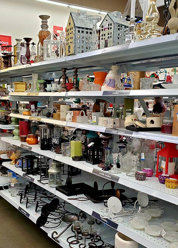 Glassware, candle holders, and decorative treasures stacked like an indoor yard sale curated by someone with surprisingly good taste.