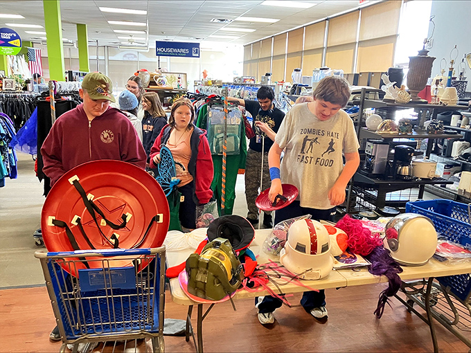 Shoppers browse the housewares section, where yesterday's kitchen gadgets become tomorrow's conversation pieces. That "Zombies Hate Fast Food" shirt speaks to me.