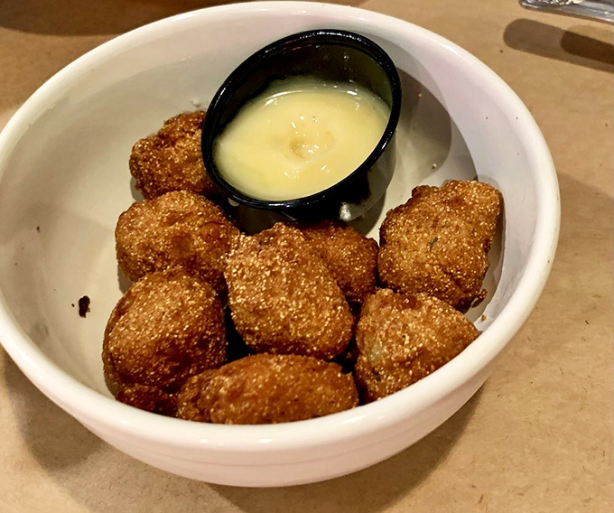 Golden-brown hush puppies with honey butter&mdash;the appetizer so good you'll contemplate ordering a second round before your entr&eacute;e even arrives.