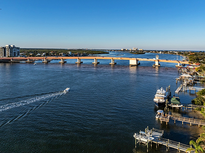 The South Causeway Bridge connects mainland to barrier island, while below, boaters navigate the Indian River with the casual confidence of longtime locals.