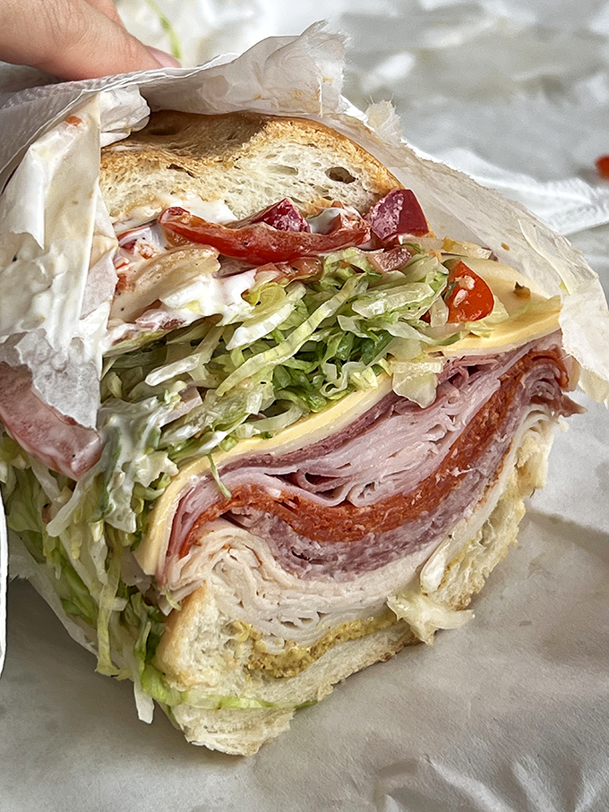 Layer upon glorious layer of Italian meats, cheese, and veggies—this isn't just a sandwich, it's an architectural achievement.