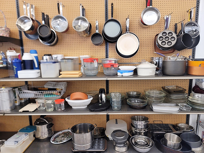 The cookware wall looks like Julia Child's kitchen exploded in the most organized, wonderful way possible.
