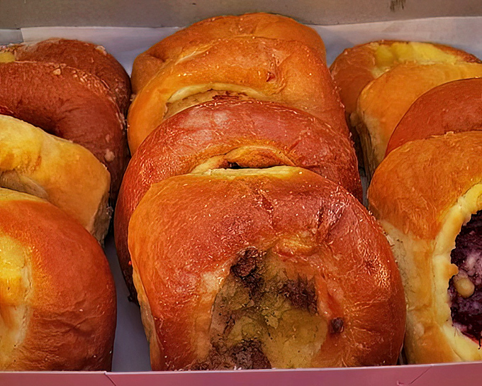 Golden-brown kolaches gleam like edible jewelry, each one a perfect pocket of dough cradling fruit fillings that grandmothers everywhere would approve of.