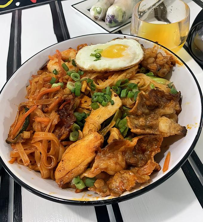 Korean Fire Noodles topped with a sunny-side-up egg&mdash;where spice meets art. Your taste buds will applaud while your sinuses clear!