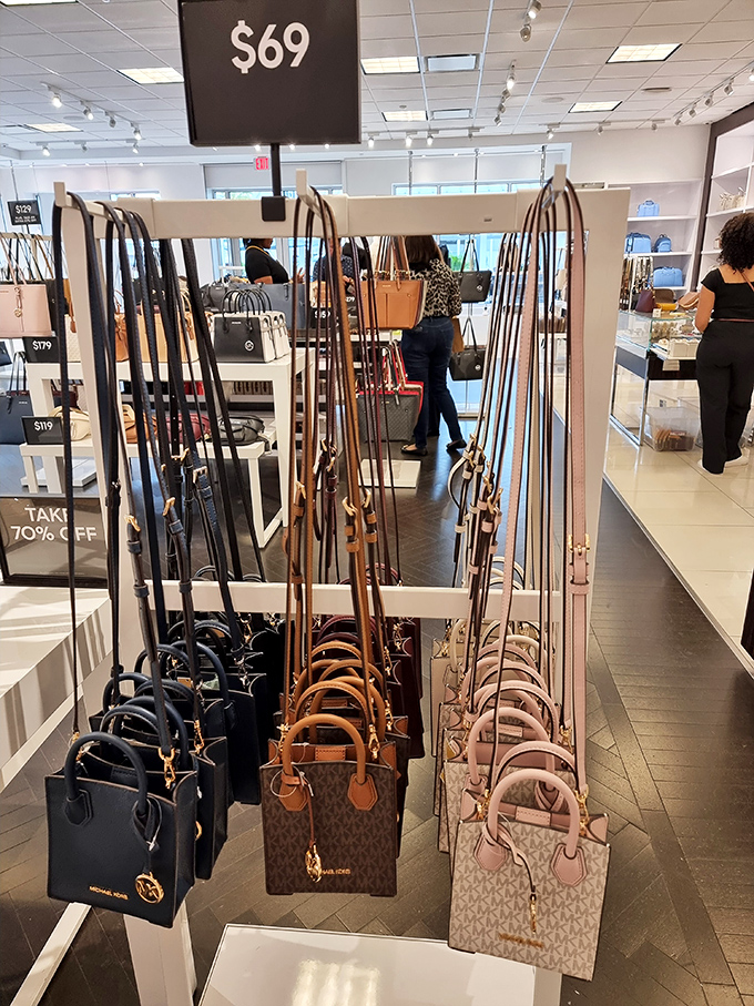 Designer handbags hanging like art installations, each one whispering "take me home" at prices that won't require therapy.