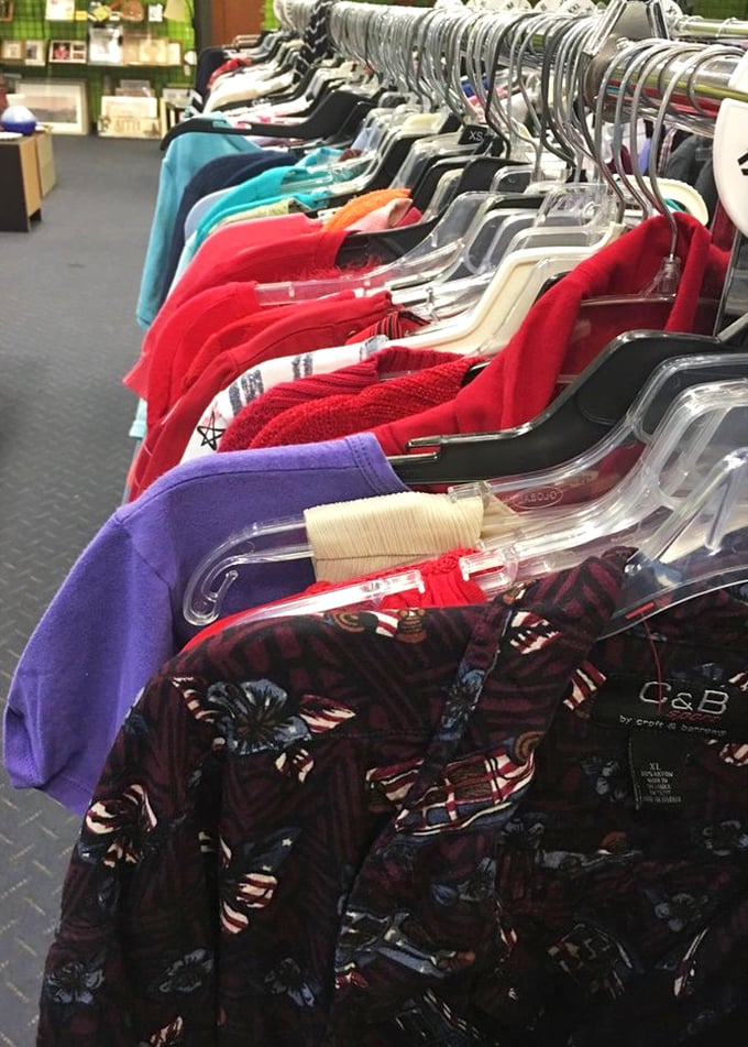 Racks of colorful possibilities hanging in patient formation. Each hanger holds someone's past fashion statement waiting to become your next favorite outfit.