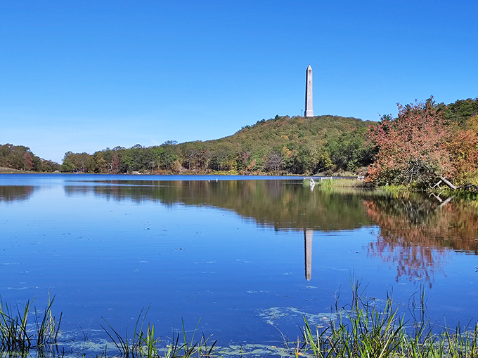 Lake Marcia mirrors the monument and autumn foliage in its still waters. Even the clouds seem to pause here, admiring their reflection in this mountain-top oasis.