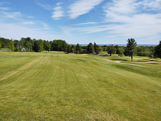 Golf with a view that makes even a triple-bogey feel like a win. Lake Superior stretches beyond the fairway like nature's gallery audience.