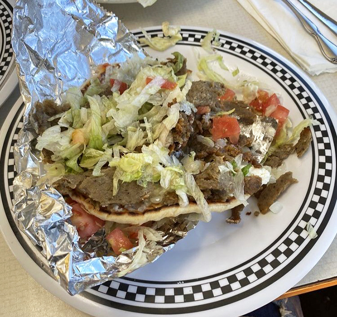 Behold the star of the show: thinly sliced lamb, crispy-edged and succulent, nestled in a warm pita with fresh toppings. Poetry on a plate.