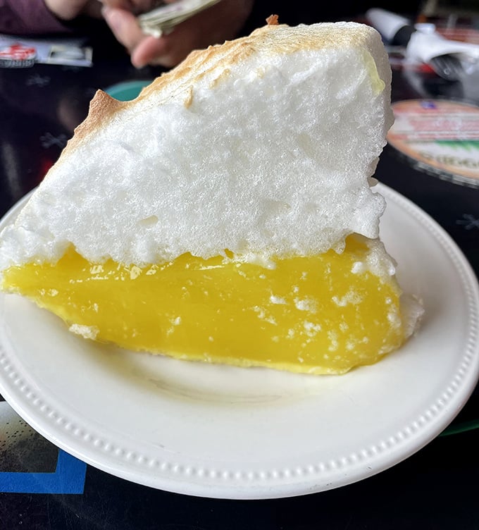 Behold the star attraction: lemon meringue pie with cloud-like topping so tall it practically needs FAA clearance to leave the kitchen.