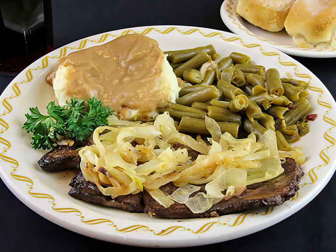Behold the legendary liver and onions! Tender slices nestled under caramelized onions with sides that refuse to be mere supporting characters.