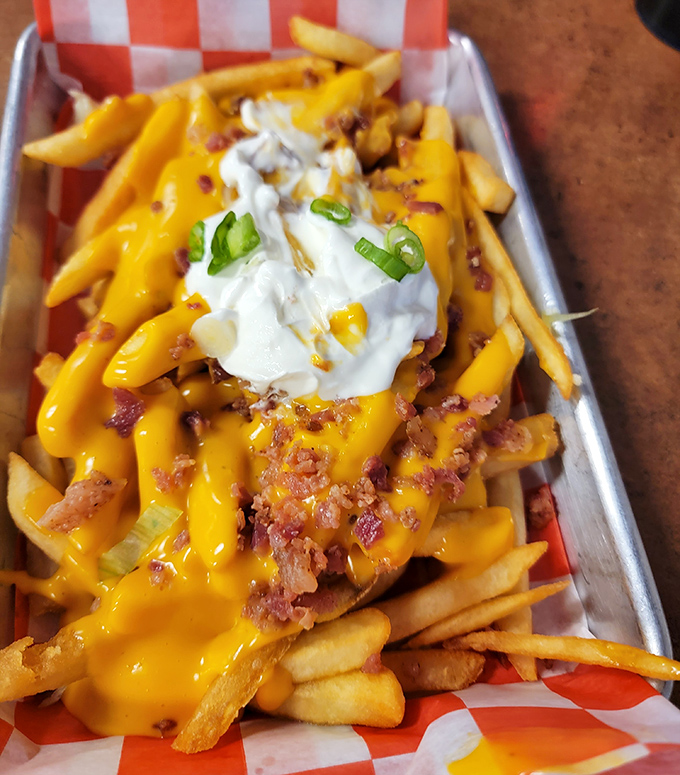 Behold the star attraction: loaded fries that don't just speak to you, they sing a full-on cheese-and-bacon aria with a sour cream encore.
